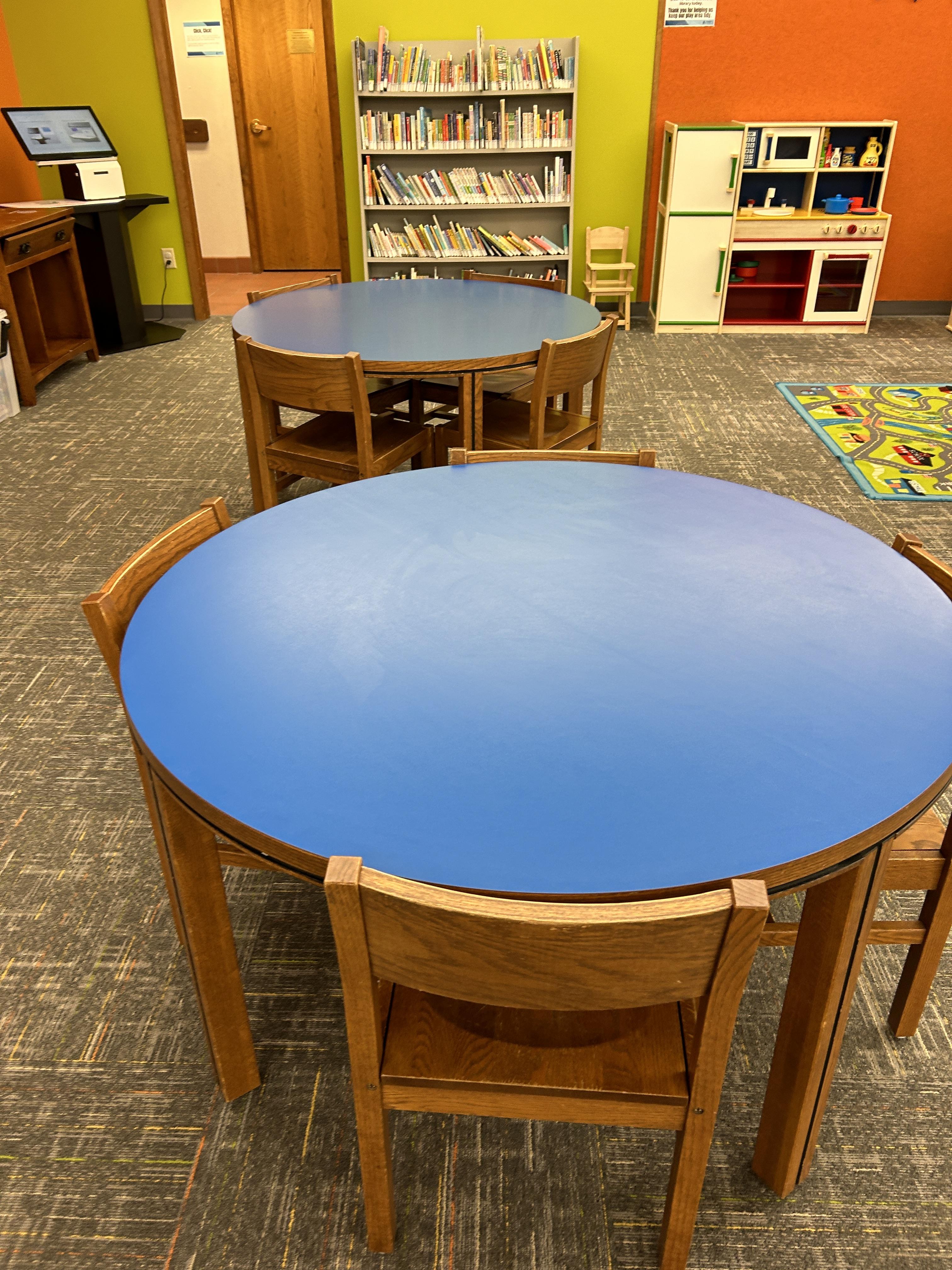 Blue top wooden tables with four chairs | Reaching Across Illinois Library System